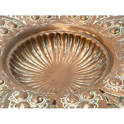 A pierced copper inset tray. Late 19th Century. Embossed flowers and ...