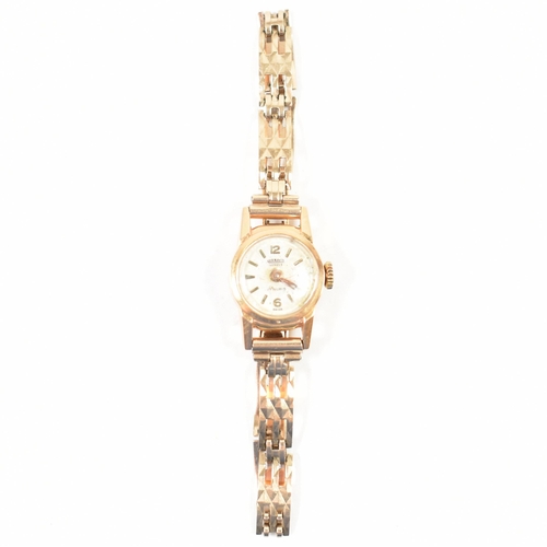 A vintage gold Cornavin wrist watch. The watch having a round face with ...