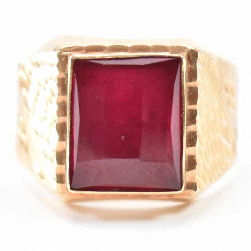 A vintage gold and synthetic ruby ring. The ring having a rectangular ...