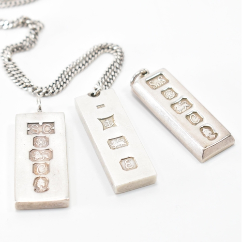 A group of hallmarked silver ingot pendants & chain. The lot to include ...