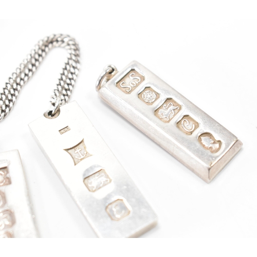 A group of hallmarked silver ingot pendants & chain. The lot to include ...