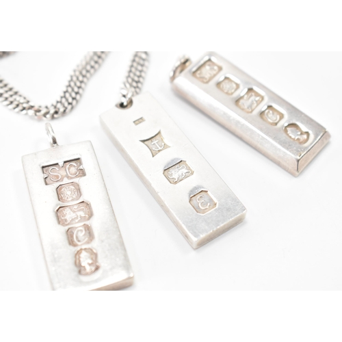 A group of hallmarked silver ingot pendants & chain. The lot to include ...