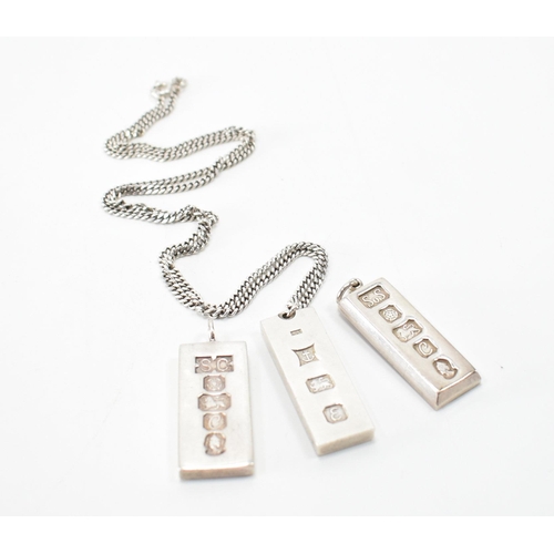 A group of hallmarked silver ingot pendants & chain. The lot to include ...