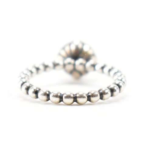 A Pandora silver ring in original box. The ring having a reeded band ...