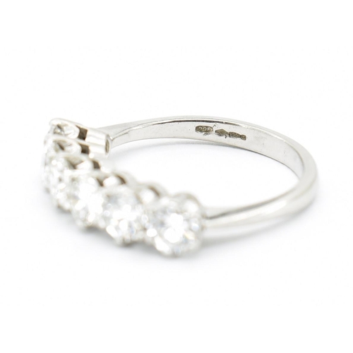 A hallmarked platinum and diamond six stone ring. The ring set with six ...