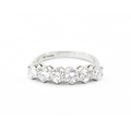 A hallmarked platinum and diamond six stone ring. The ring set with six ...