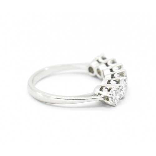 A hallmarked platinum and diamond six stone ring. The ring set with six ...