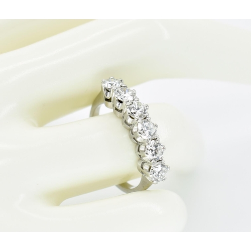 A hallmarked platinum and diamond six stone ring. The ring set with six ...