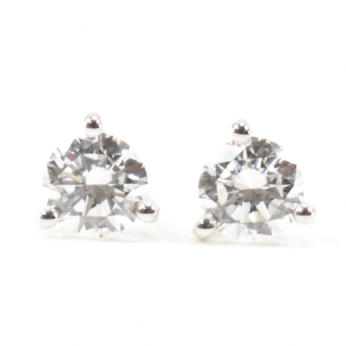 A pair of 18ct gold and diamond stud earrings. Each earring being prong ...