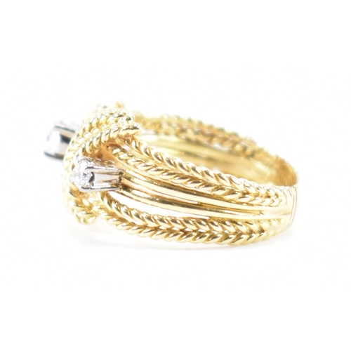 A vintage gold and diamond knot ring. The rope design ring being set ...