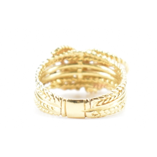 A vintage gold and diamond knot ring. The rope design ring being set ...