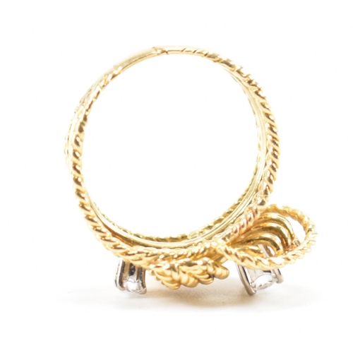 A vintage gold and diamond knot ring. The rope design ring being set ...