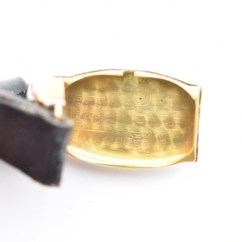 Two yellow gold wrist watches with leatherette straps. The first a ...