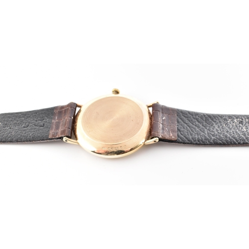 Two yellow gold wrist watches with leatherette straps. The first a ...
