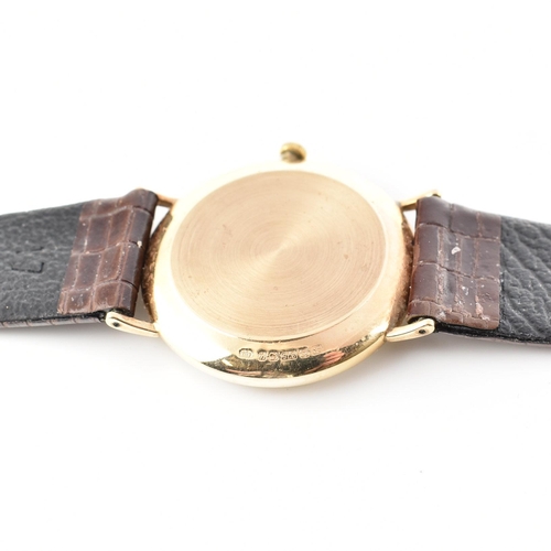 Two yellow gold wrist watches with leatherette straps. The first a ...