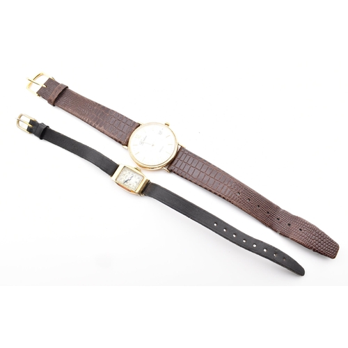 Two yellow gold wrist watches with leatherette straps. The first a ...