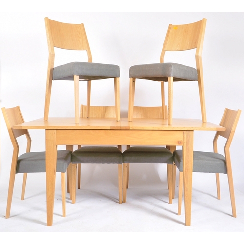 Ercol - A contemporary light oak rectangular extending dining table with chairs. The table having a