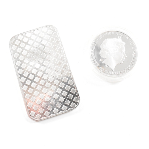 A cased 2016 Gibraltar twenty pound coin and a fine silver ingot. The ...