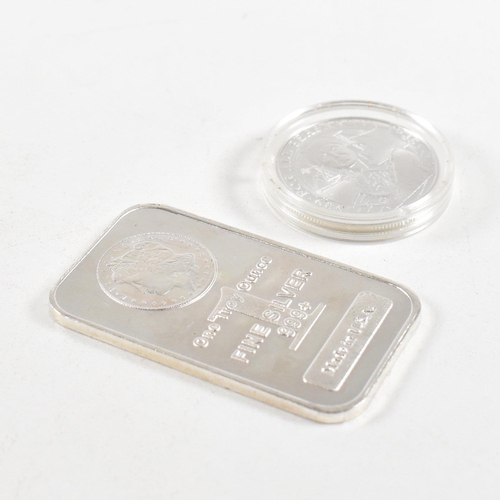 A cased 2016 Gibraltar twenty pound coin and a fine silver ingot. The ...