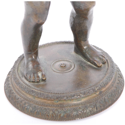 A late 19th century bronze statue of Cupid carrying a dolphin. Italian ...