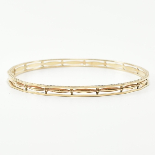 An antique 9ct yellow gold bangle armlet. The cuff arm band of faceted ...