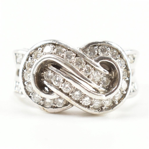 A hallmarked 9ct white gold and diamond knot design ring. The ring ...