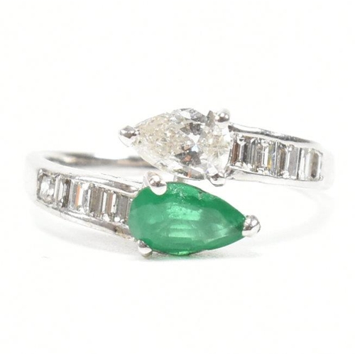 A hallmarked 18ct white gold diamond and emerald wrap around ring. The ...
