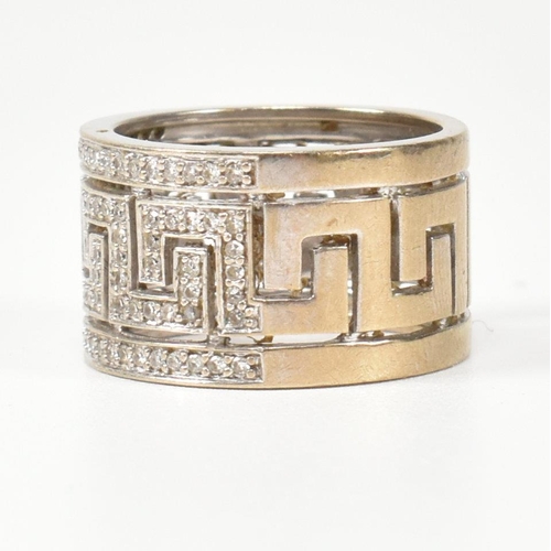 A hallmarked 9ct white gold and diamond Greek key band ring. The ring ...