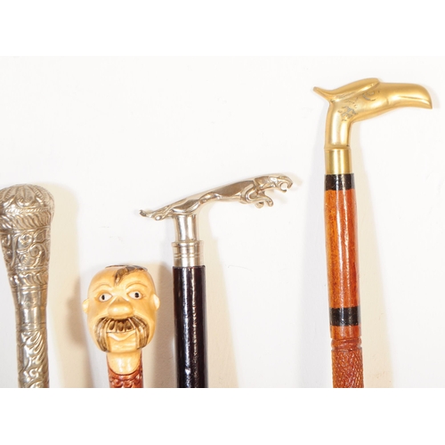 A collection of vintage 20th century novelty walking canes / swagger ...