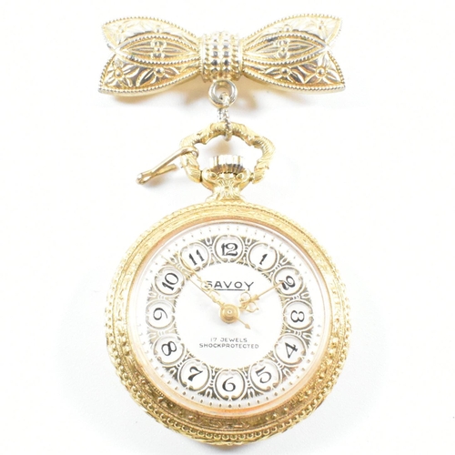 Three gold tone metal wristwatches and a brooch watch. The lot to ...